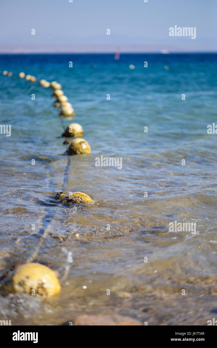 sea coast with waves and rope with floating spheres Stock Photo - Alamy