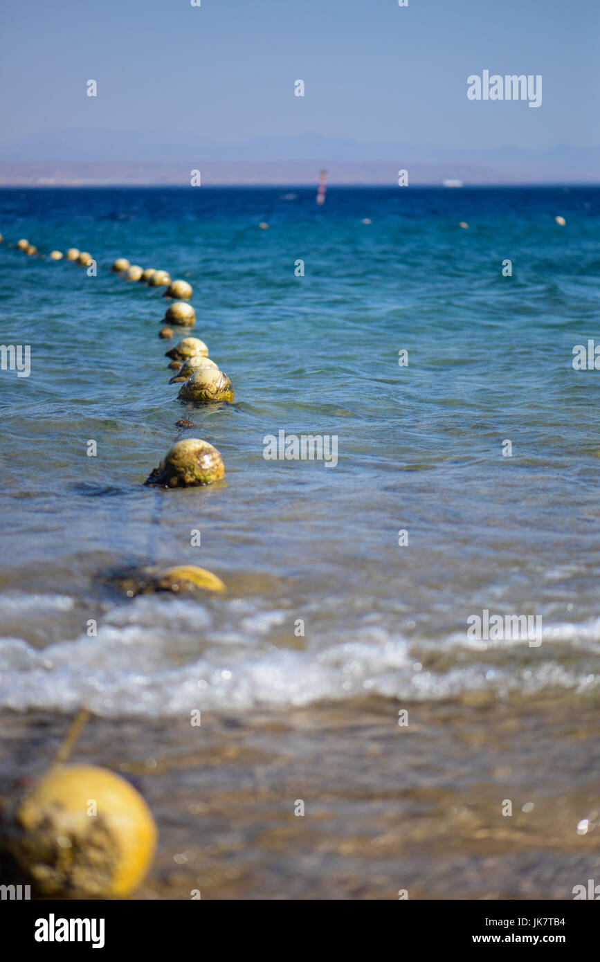 sea coast with waves and rope with floating spheres Stock Photo - Alamy