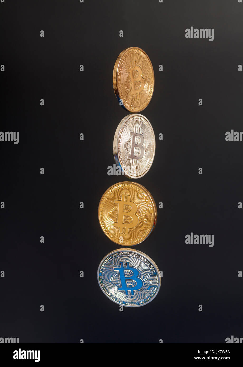 Four virtual coins bitcoins on black background Stock Photo - Alamy