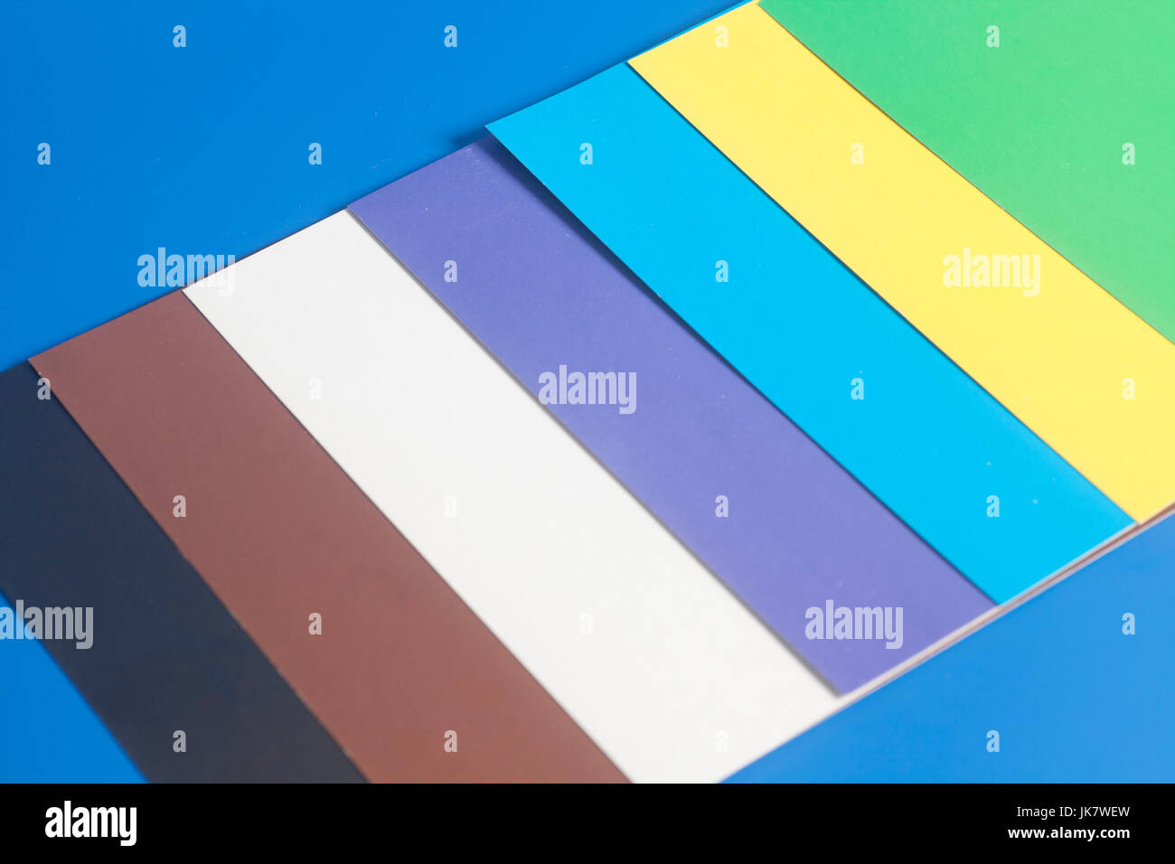 Colourful paper sheets on blue background Stock Photo - Alamy