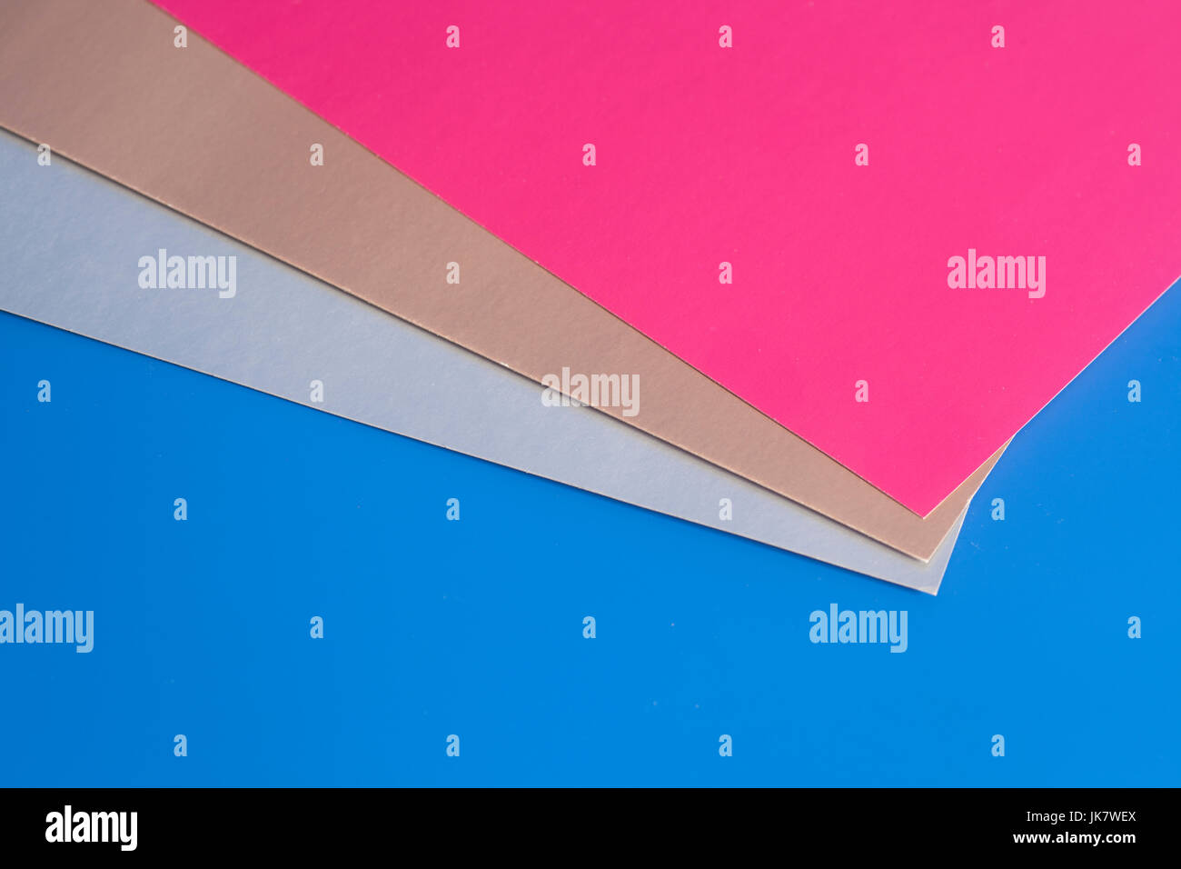 Colourful paper sheets on blue background Stock Photo - Alamy