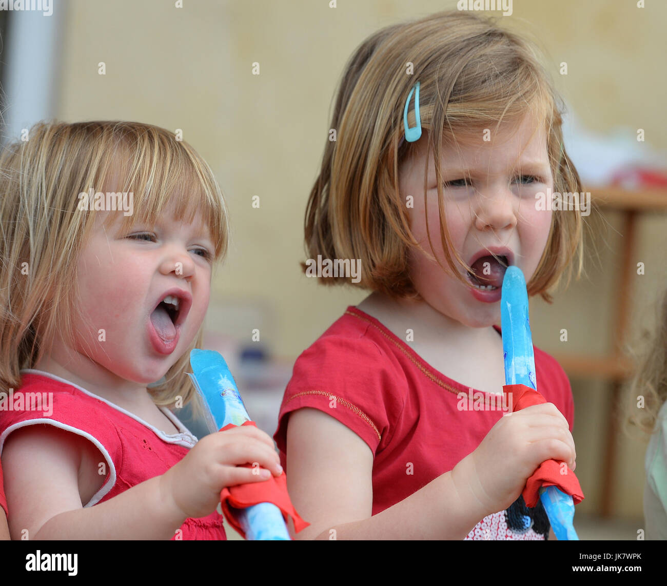 Two girls eating ice lollies hi-res stock photography and images - Alamy