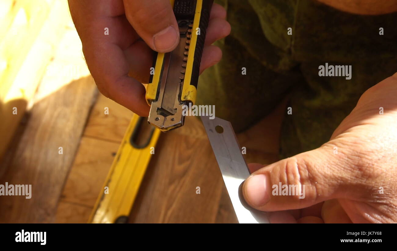 the process of replacing blades, yellow utility knife Stock Photo - Alamy