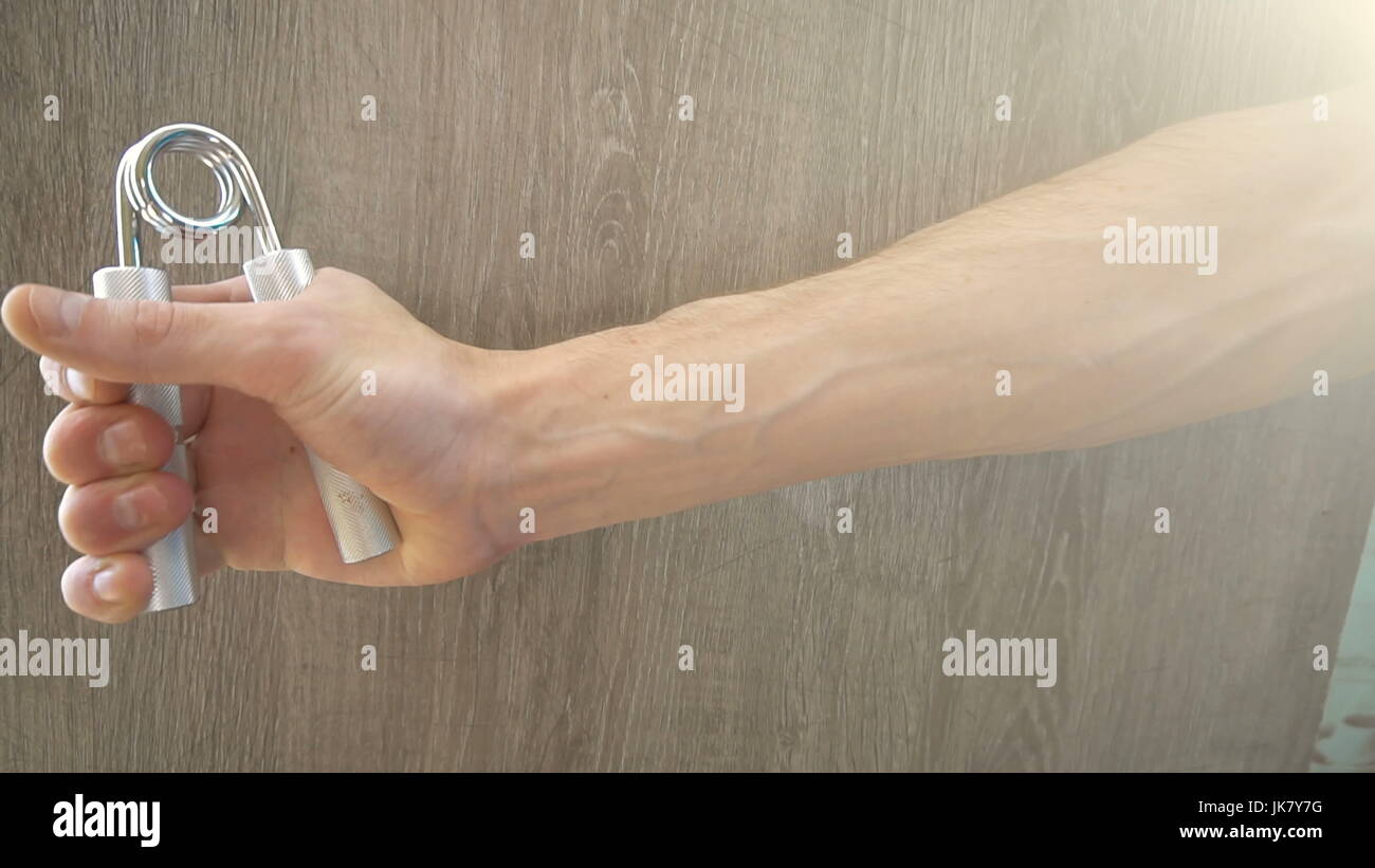 young athlete compresses and decompresses silver metallic manual ...