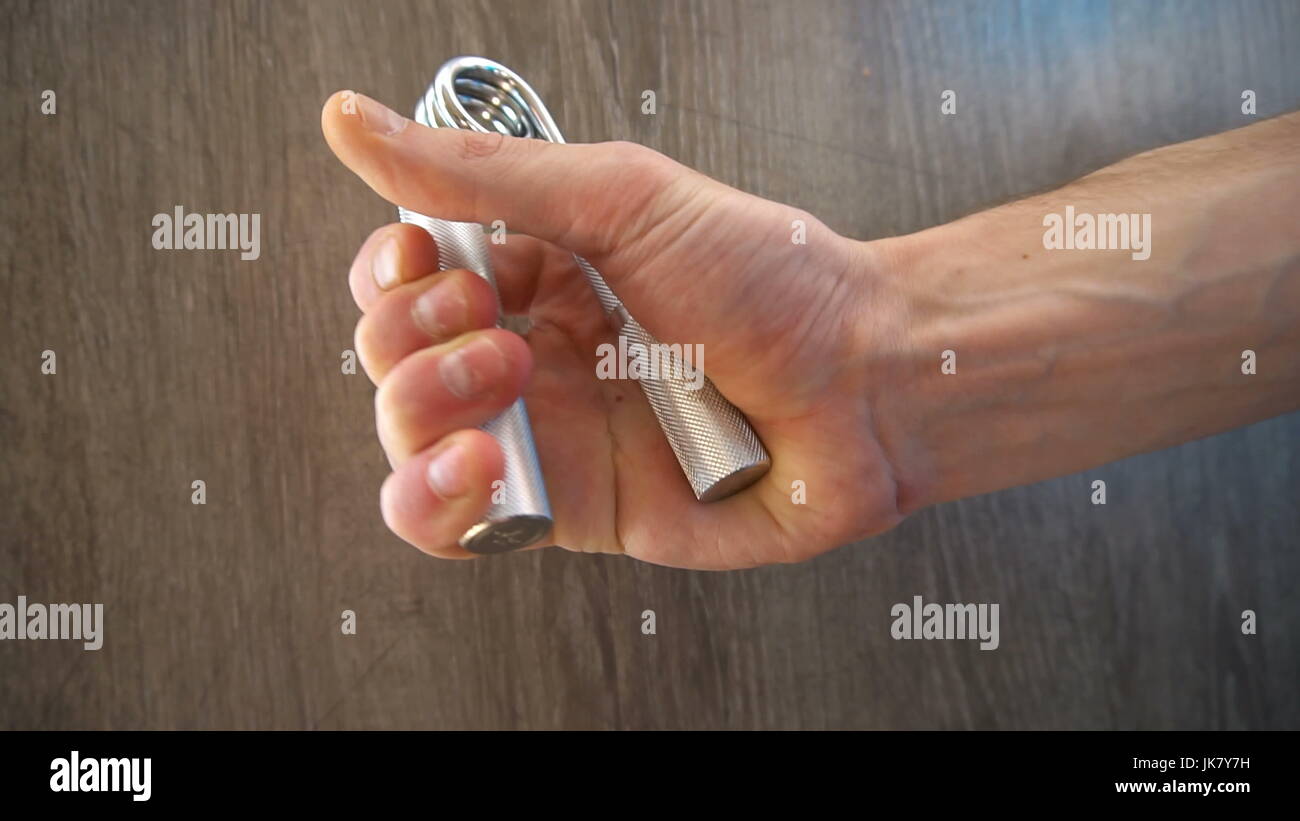 young athlete compresses and decompresses silver metallic manual ...