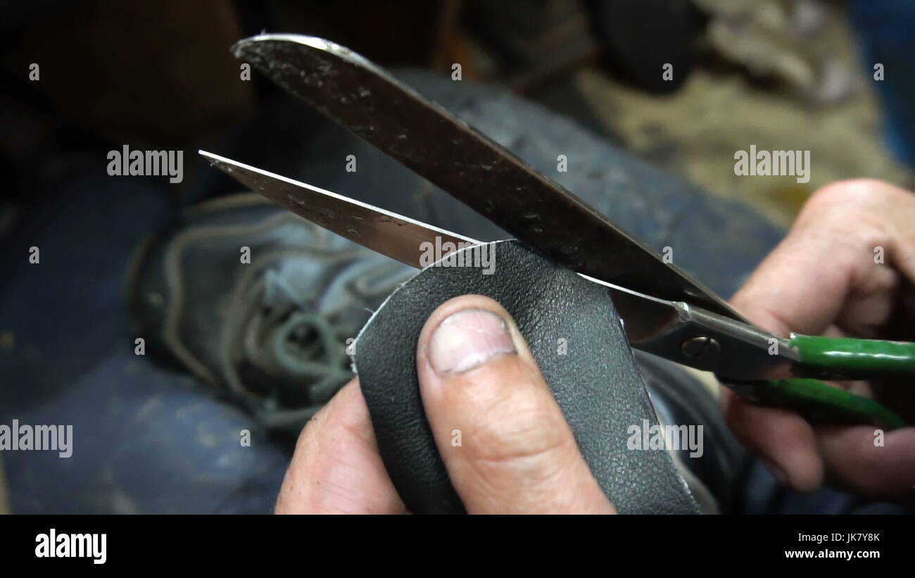 Shoemaker cuts sole shoe hi-res stock photography and images - Alamy