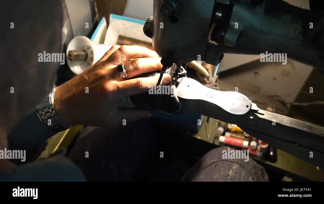 Shoemaker repairing shoes Workshop 4k Stock Photo - Alamy