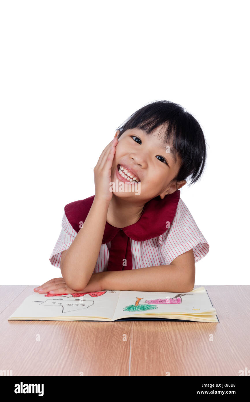 Asian Little Chinese girl reading a painting book in isolated white ...