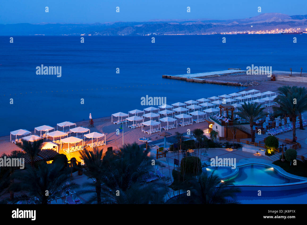 Jordan, Aqaba, elevated view over hotel swimming pool and Red Sea, dawn ...
