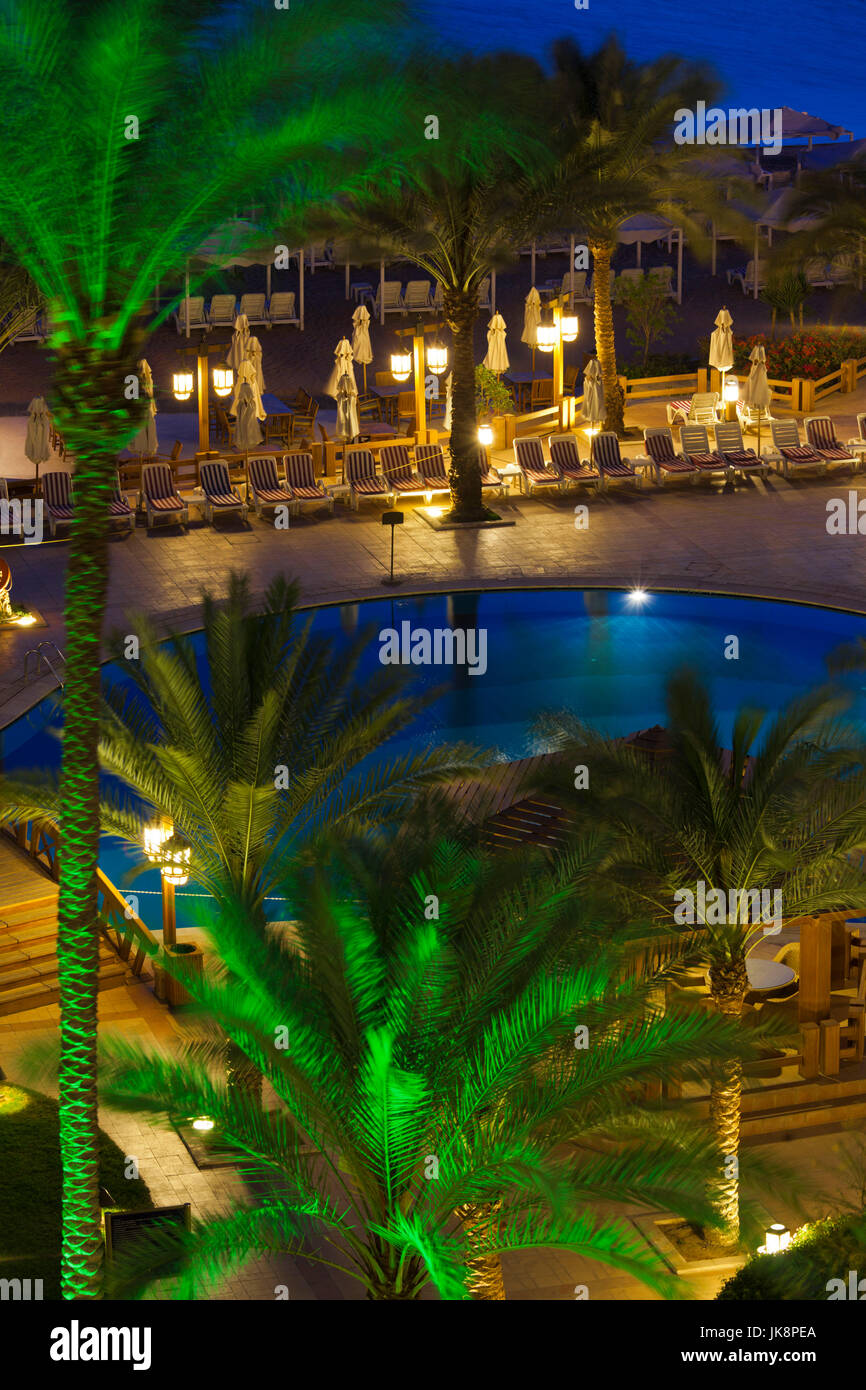 Jordan, Aqaba, elevated view of hotel swimming pool, dusk Stock Photo ...