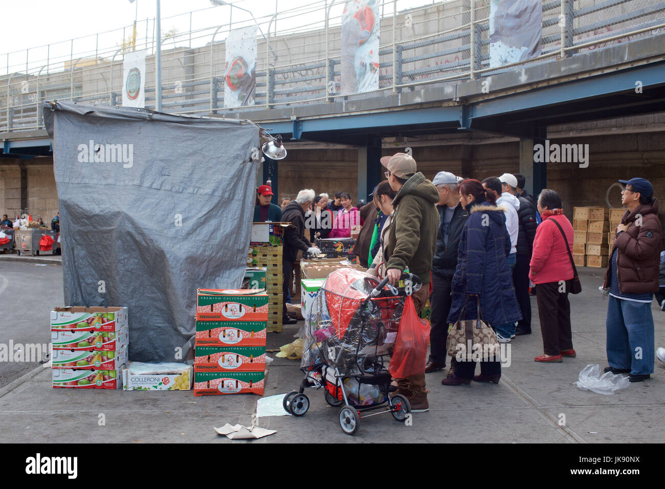 Chinatown street market underneath the Manhattan Bridge in New York, NY ...