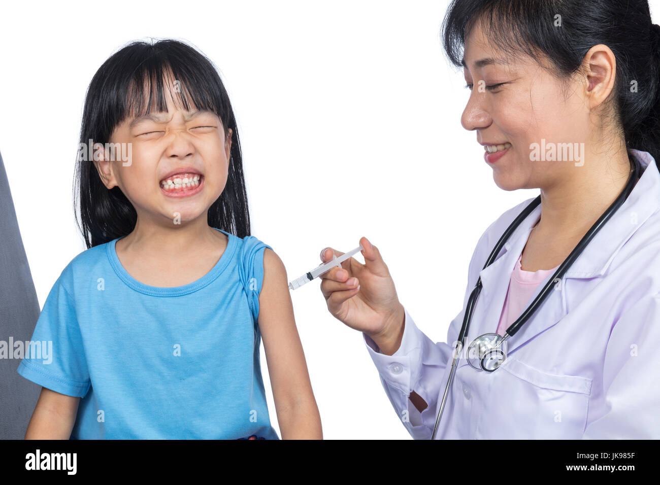 Asian female doctor giving a Chinese little girl injection in isolated ...