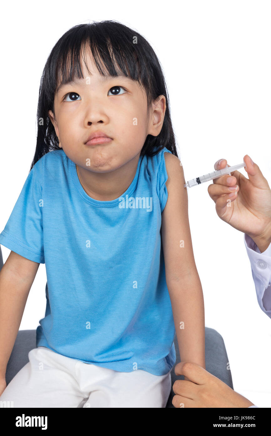Asian little Chinese girl receiving an injection in isolated White ...