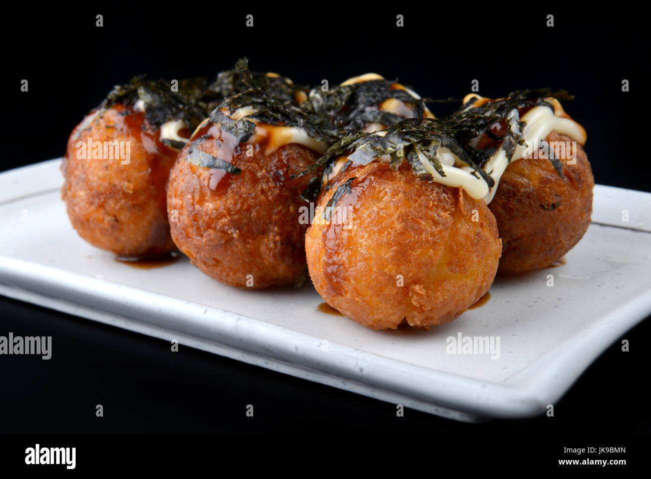 Takoyaki or Japanese octopus ball fried top on with sauce and seaweed ...