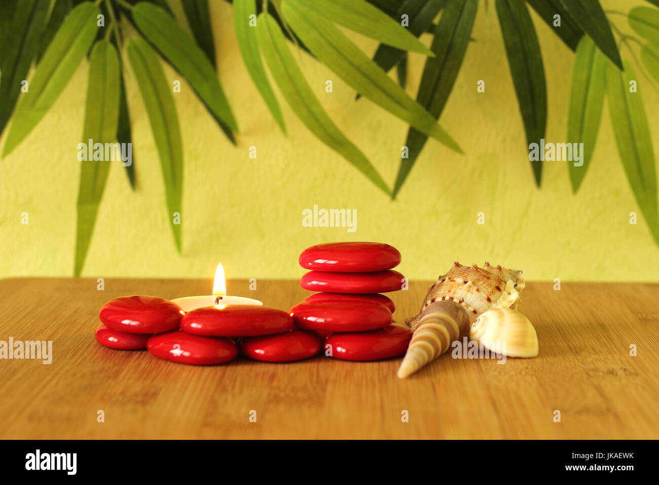 Small red stones arranged in columns in zen lifestyle with a candle and ...