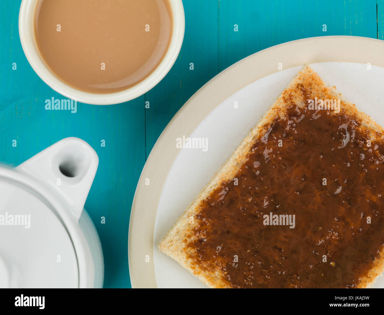 Beef Extract Spread on Toast Against a Blue Wooden Background Stock ...