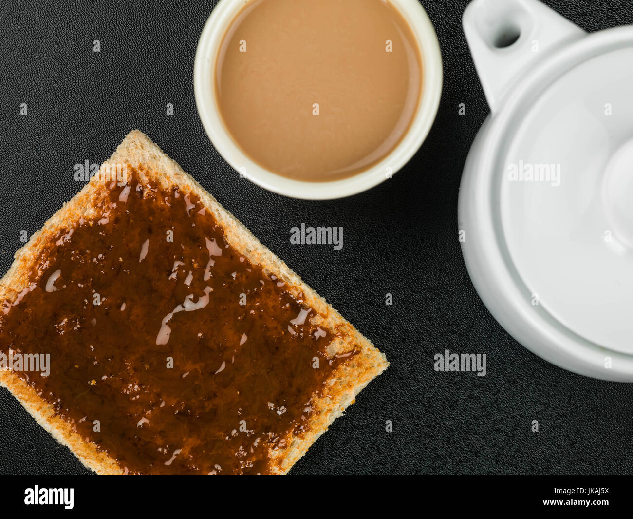Beef Extract Spread on Toast Against a Black Background Stock Photo - Alamy