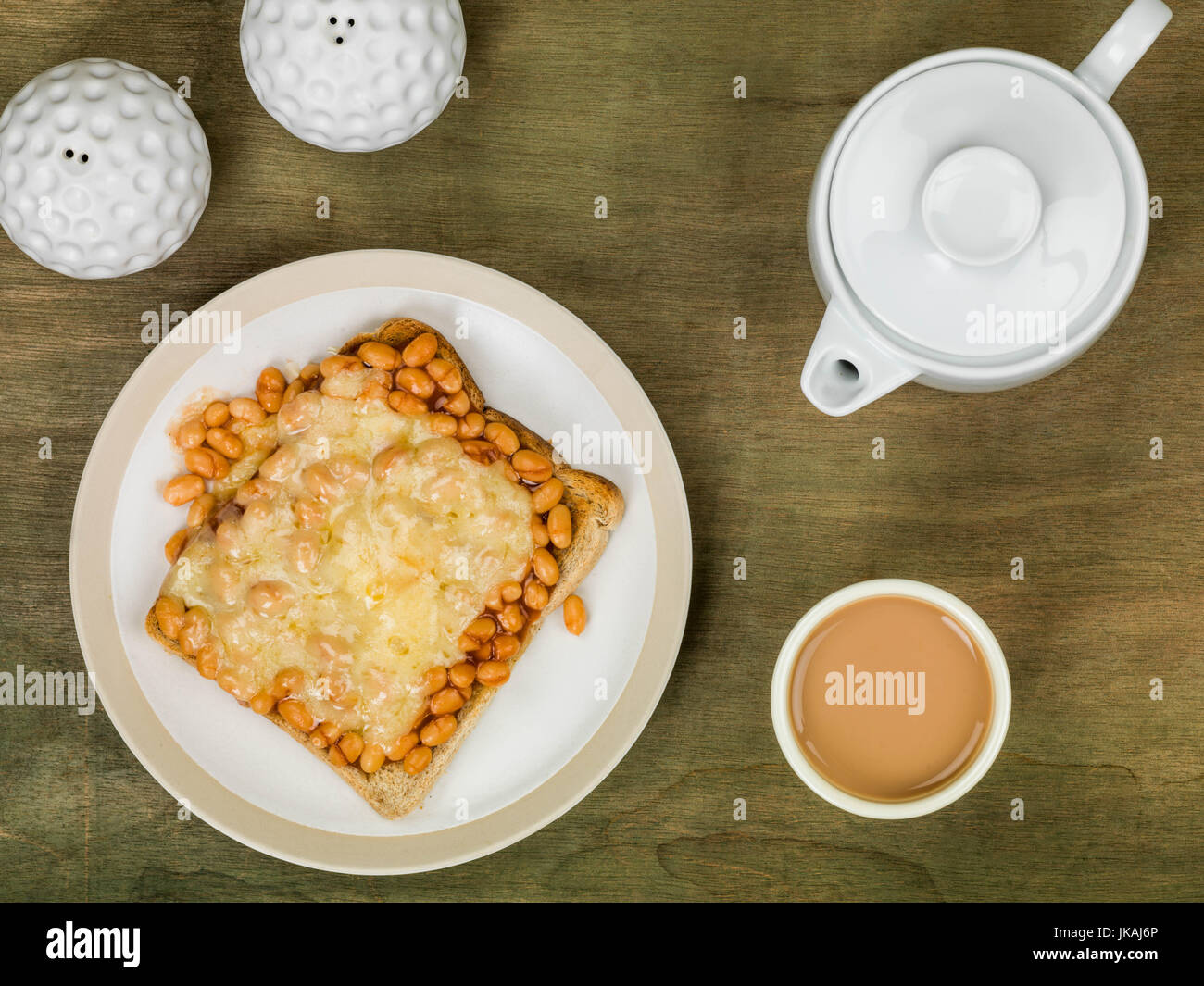 Baked Beans and Melted Cheese on Toast Against a Brown Wooden ...
