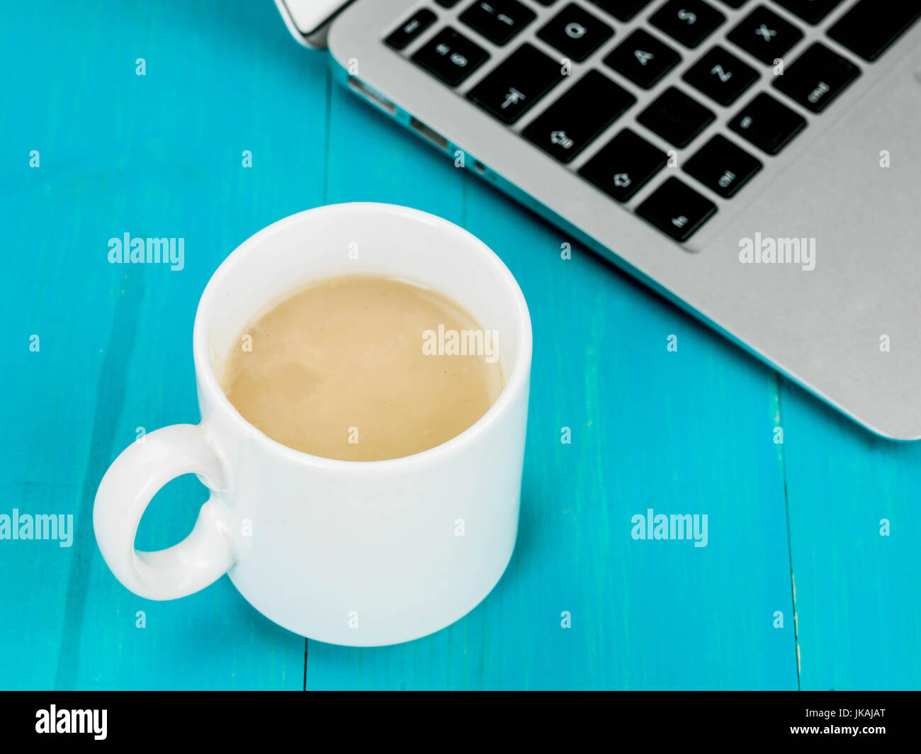 Cup of Mushroom Soup With a Laptop Computer Against a Blue Wooden ...