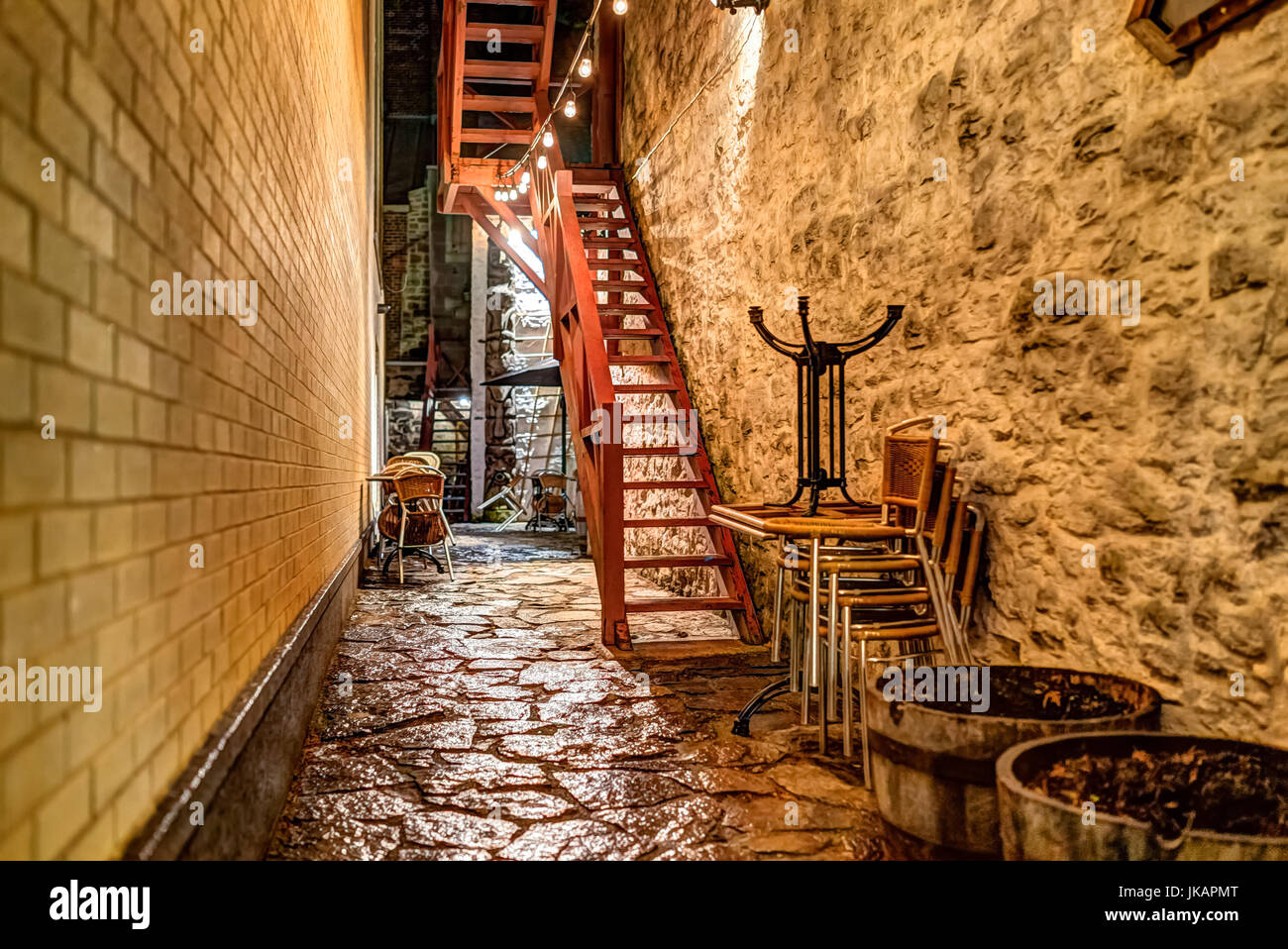 Narrow alley with cobblestone and private entrance with stairs to stone ...