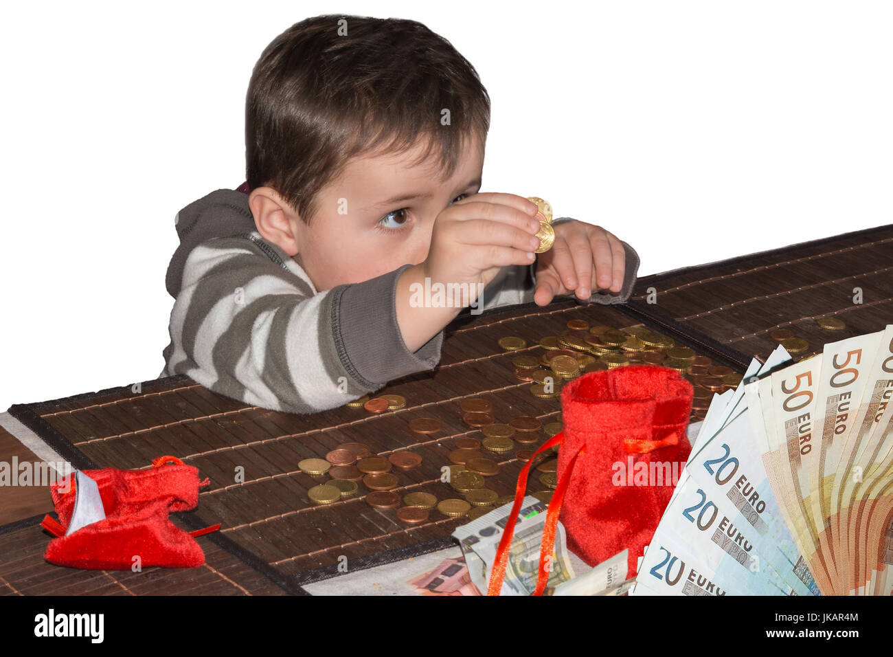 Child and a pile of money coins. Concept Save money Stock Photo - Alamy