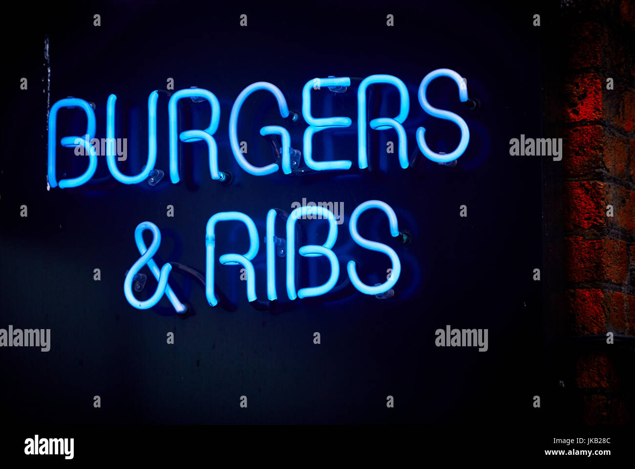 A neon sign advertising burgers and ribs Stock Photo - Alamy