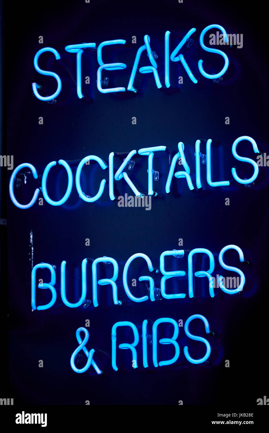 A neon sign advertising steaks, cocktails, burgers and ribs Stock Photo ...