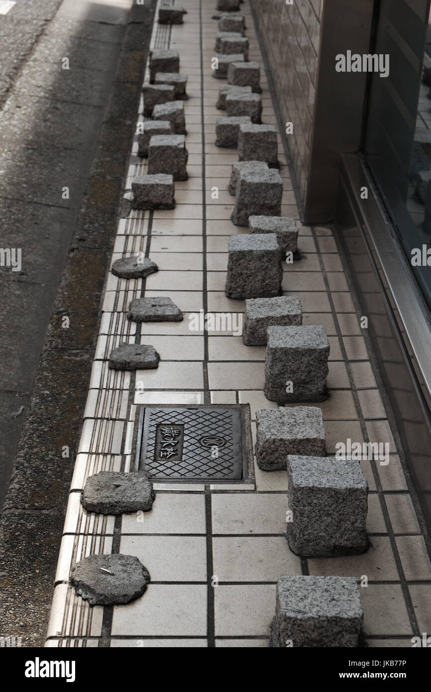 A collection of rocks on a Japanese sidewalk Stock Photo - Alamy
