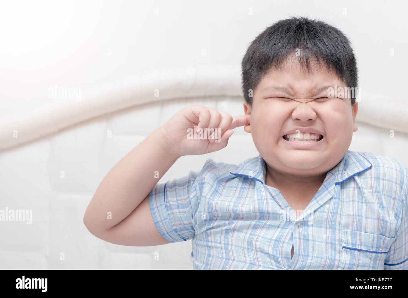 Angry unhappy kid boy covered ears the fingers and gesturing that not ...