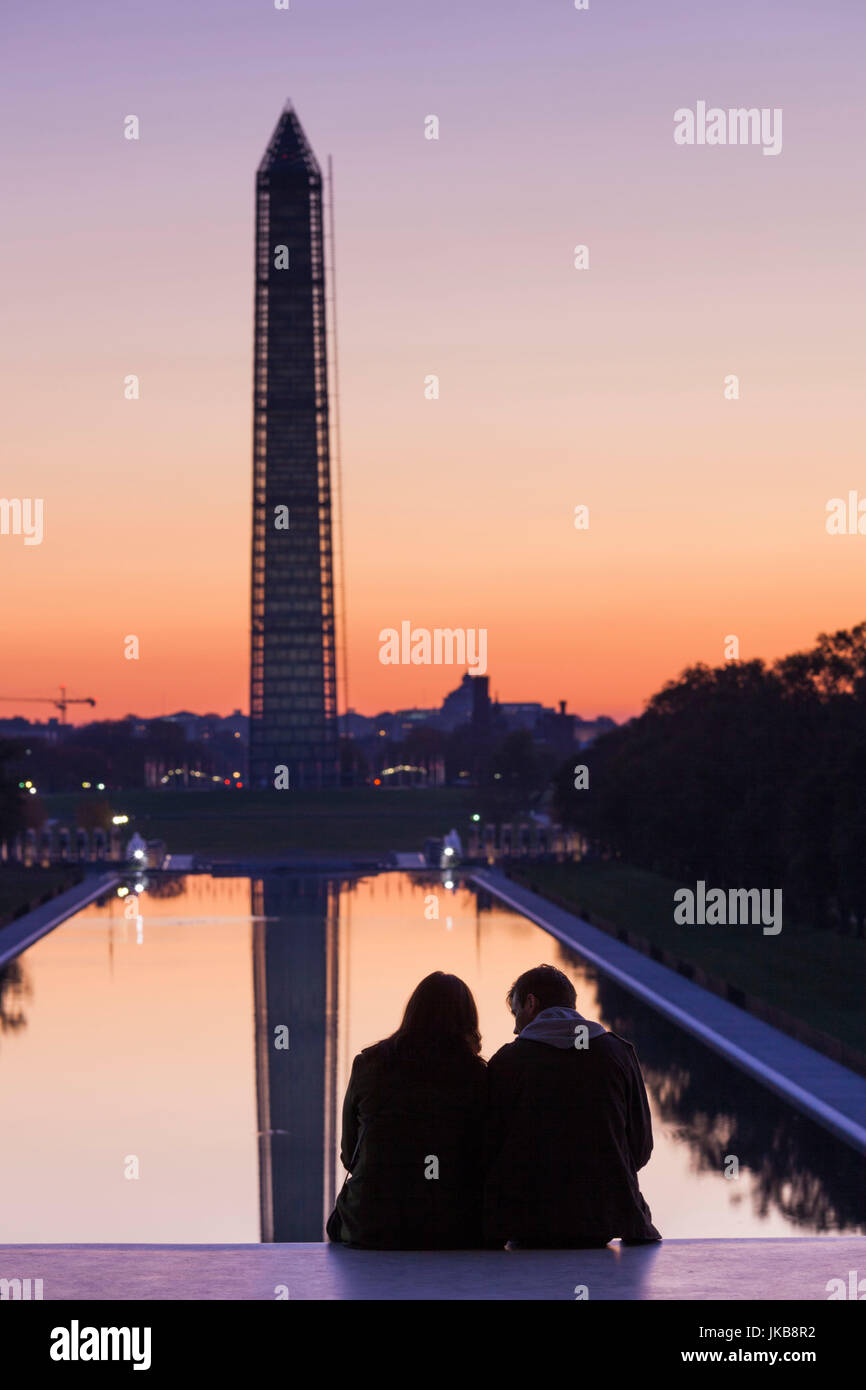 USA, Washington DC, Washington Monument with couple, at dawn Stock ...