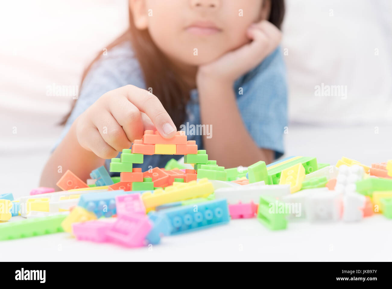 girl play block bricks on bed, education concept Stock Photo - Alamy