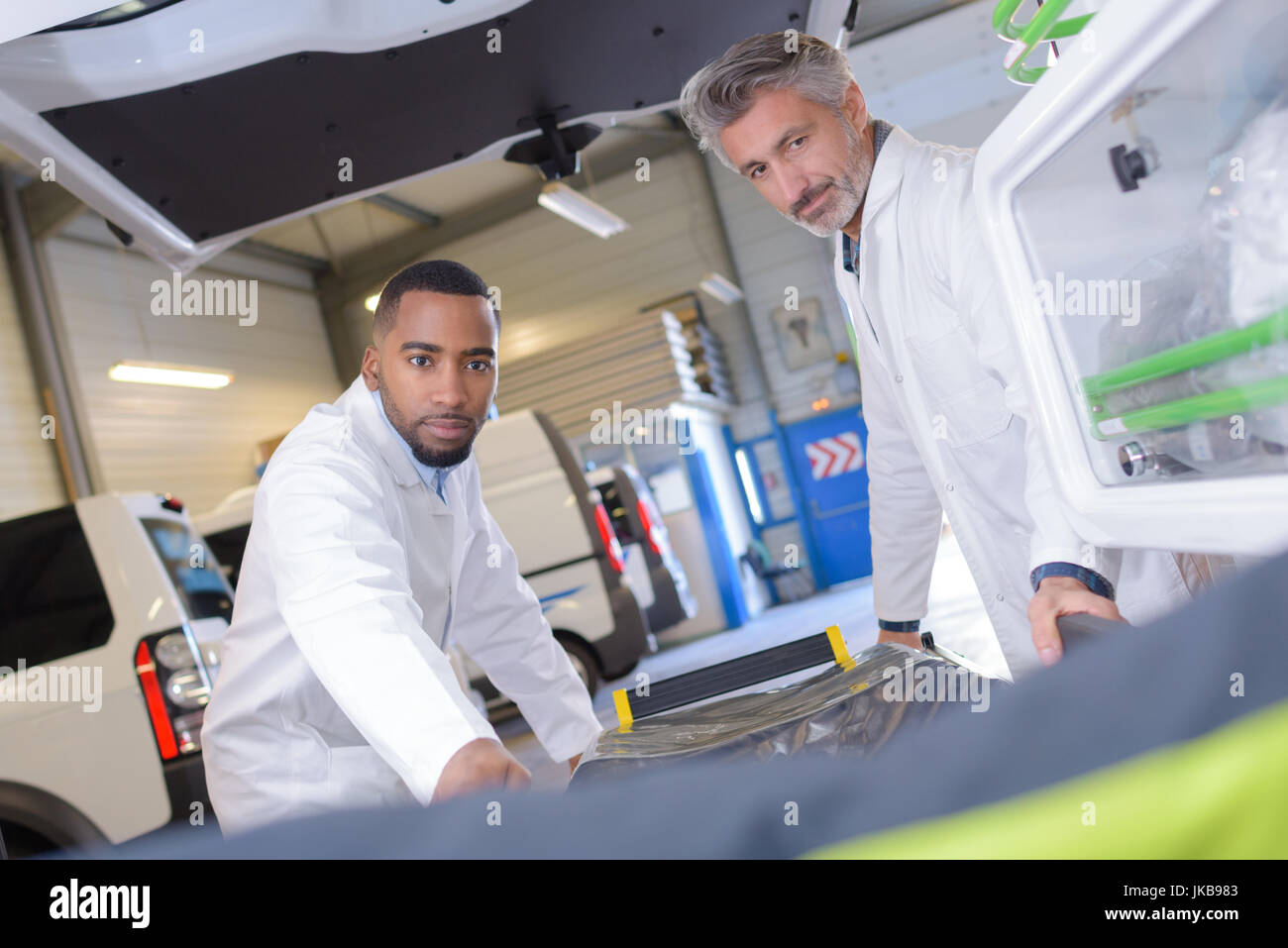 handsome paramedic with colleague Stock Photo - Alamy