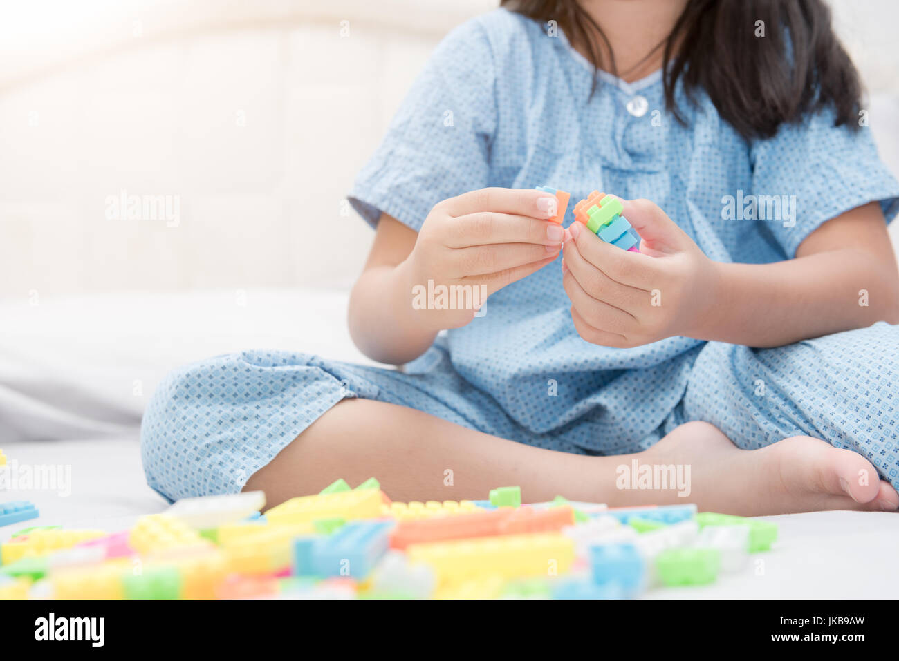 girl play block bricks on bed, education concept Stock Photo - Alamy