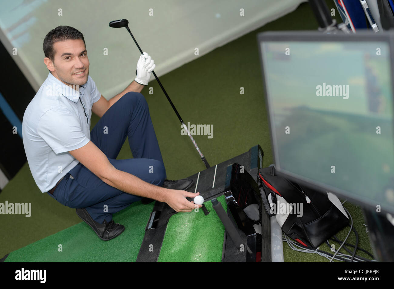 handsome man playing virtual golf Stock Photo - Alamy