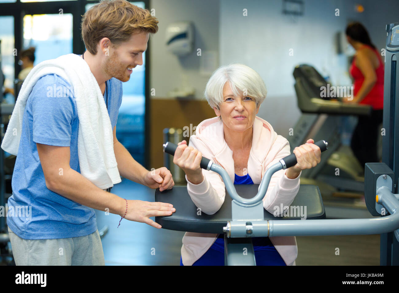 female senior in the gym assisted by the trainer Stock Photo - Alamy