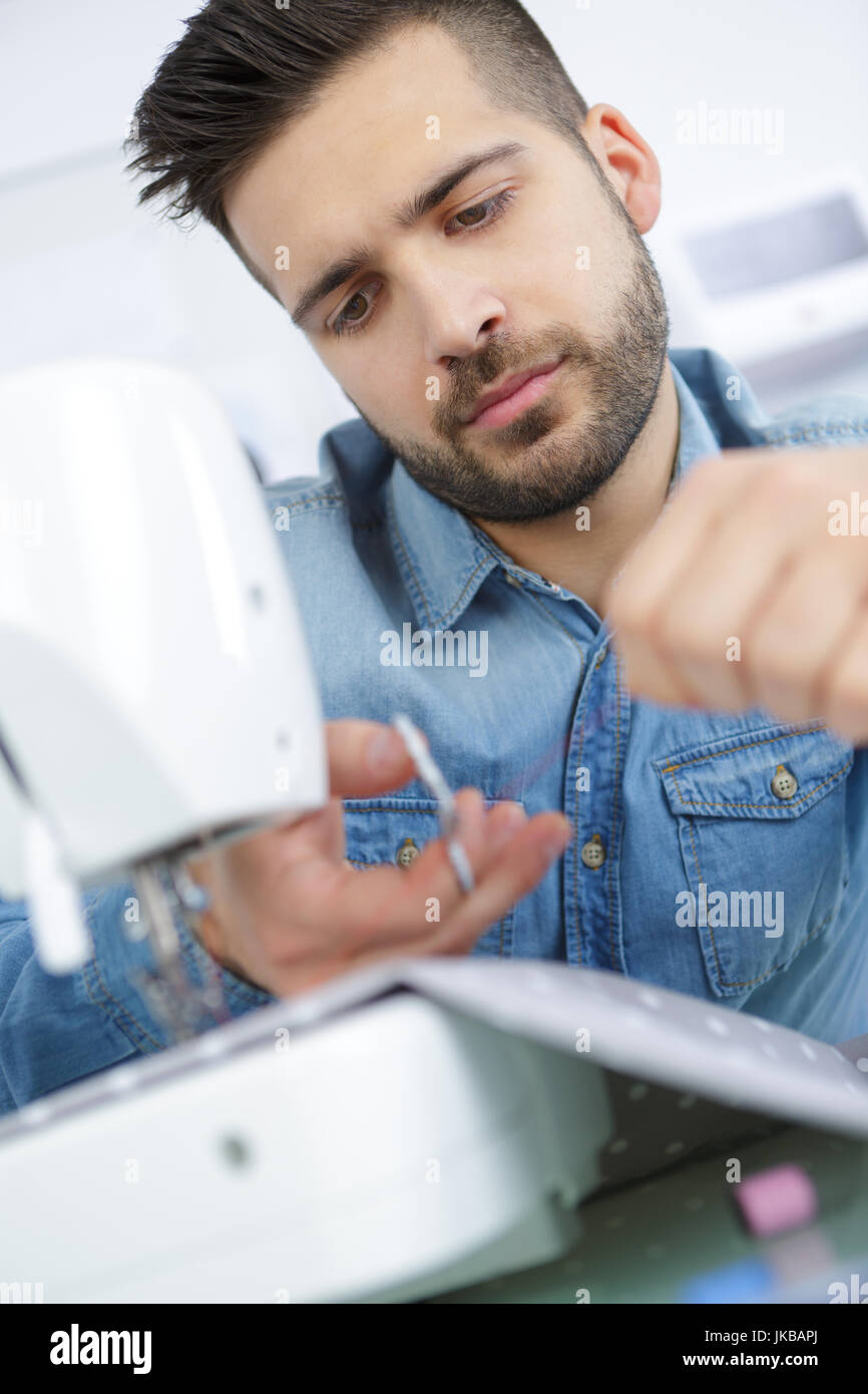 male dressmaker tailor sewing Stock Photo - Alamy