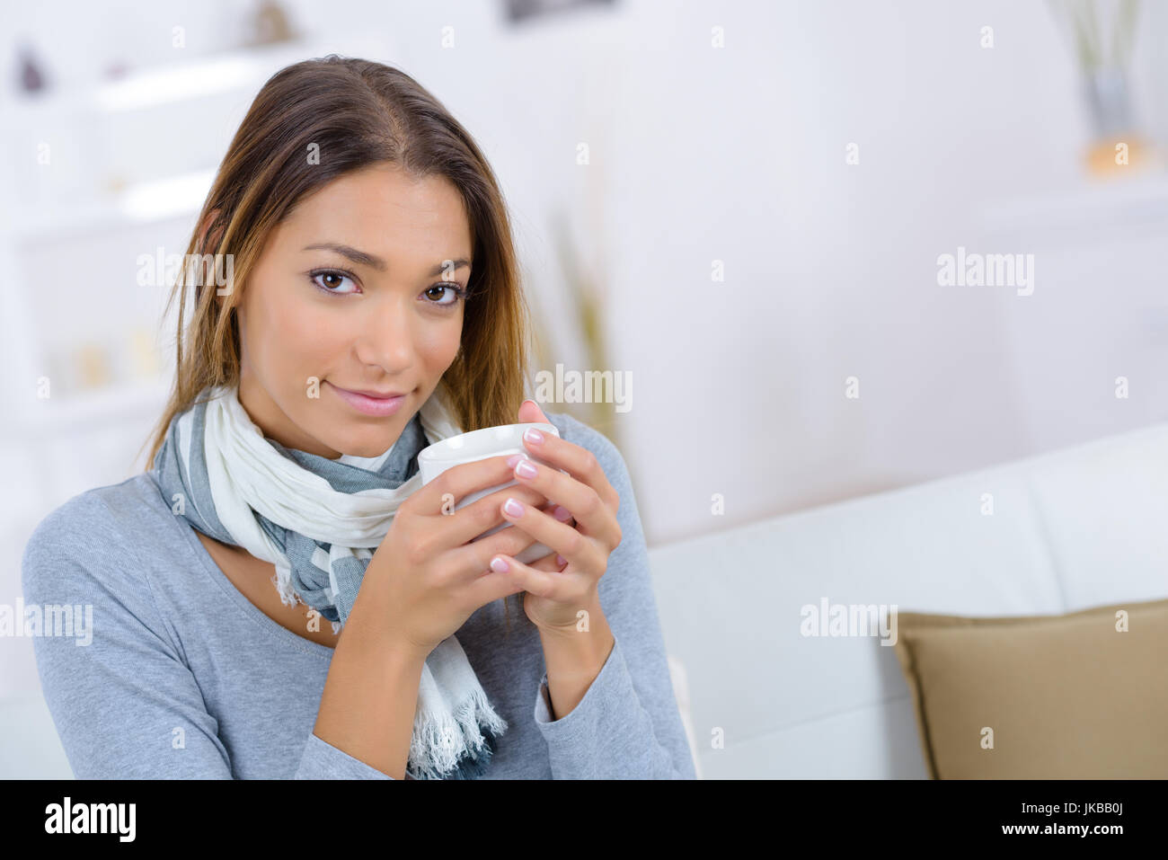 indoor portrait of a smiling caucasian woman drinking tea Stock Photo ...