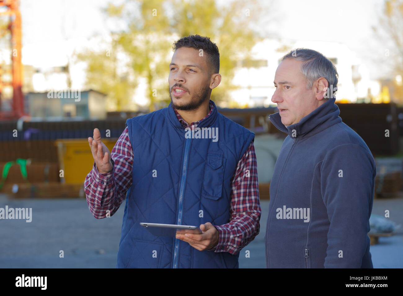 factory workers discussing outside industry Stock Photo - Alamy