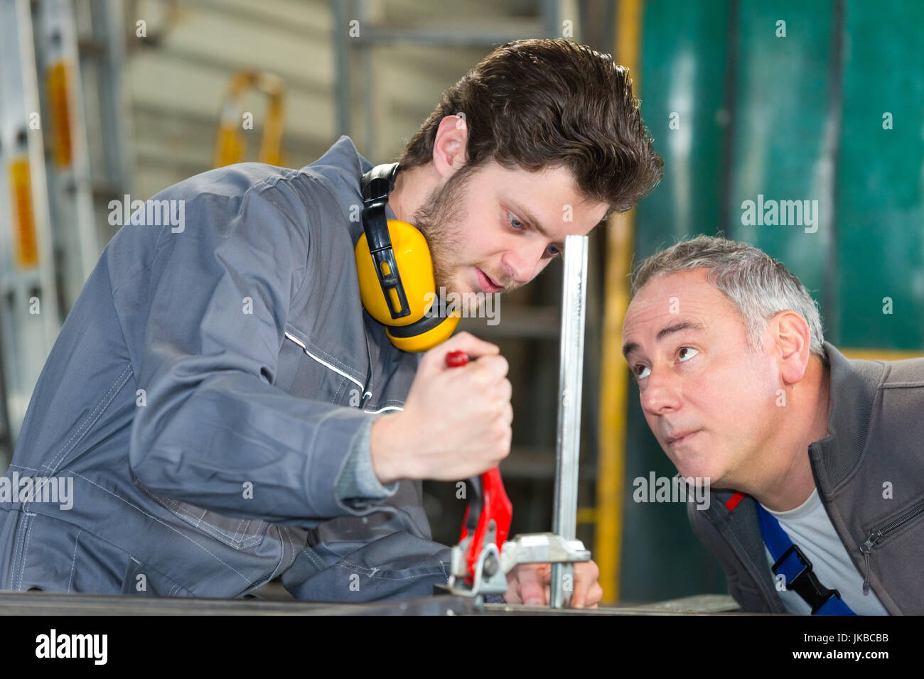 team of engineers having discussion in factory Stock Photo - Alamy