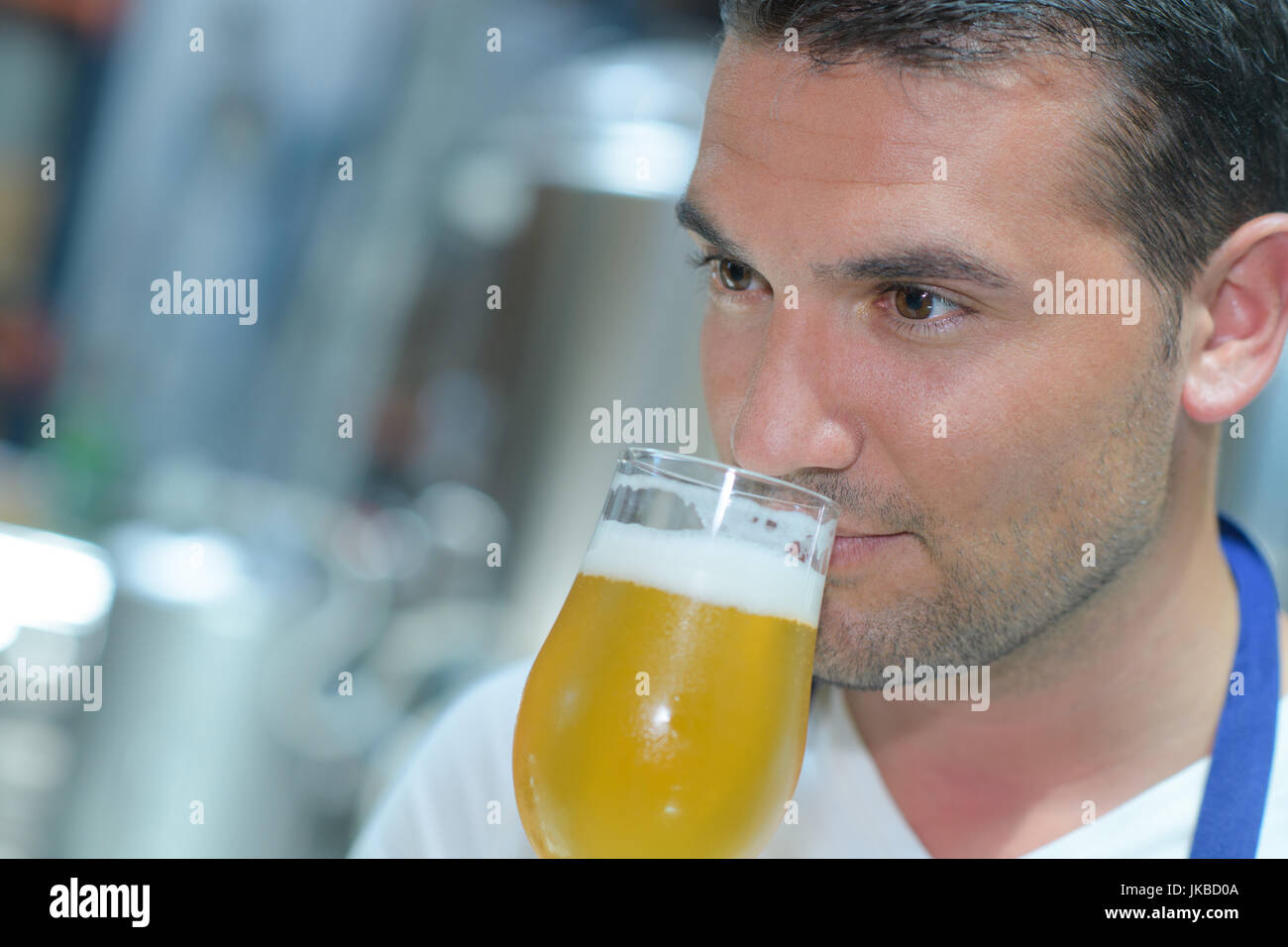 close-up of brewer smelling beer at brewery Stock Photo - Alamy