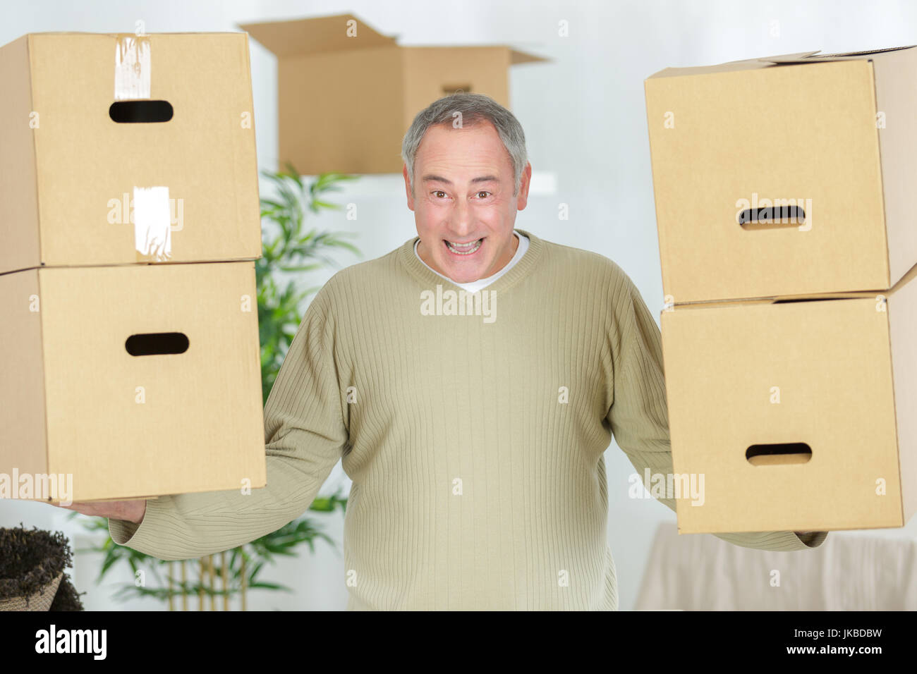 mature man holding boxes Stock Photo - Alamy