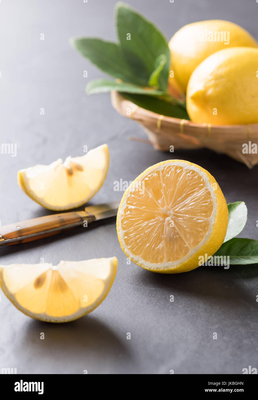 fresh sliced lemon on dark marble stone background Stock Photo - Alamy