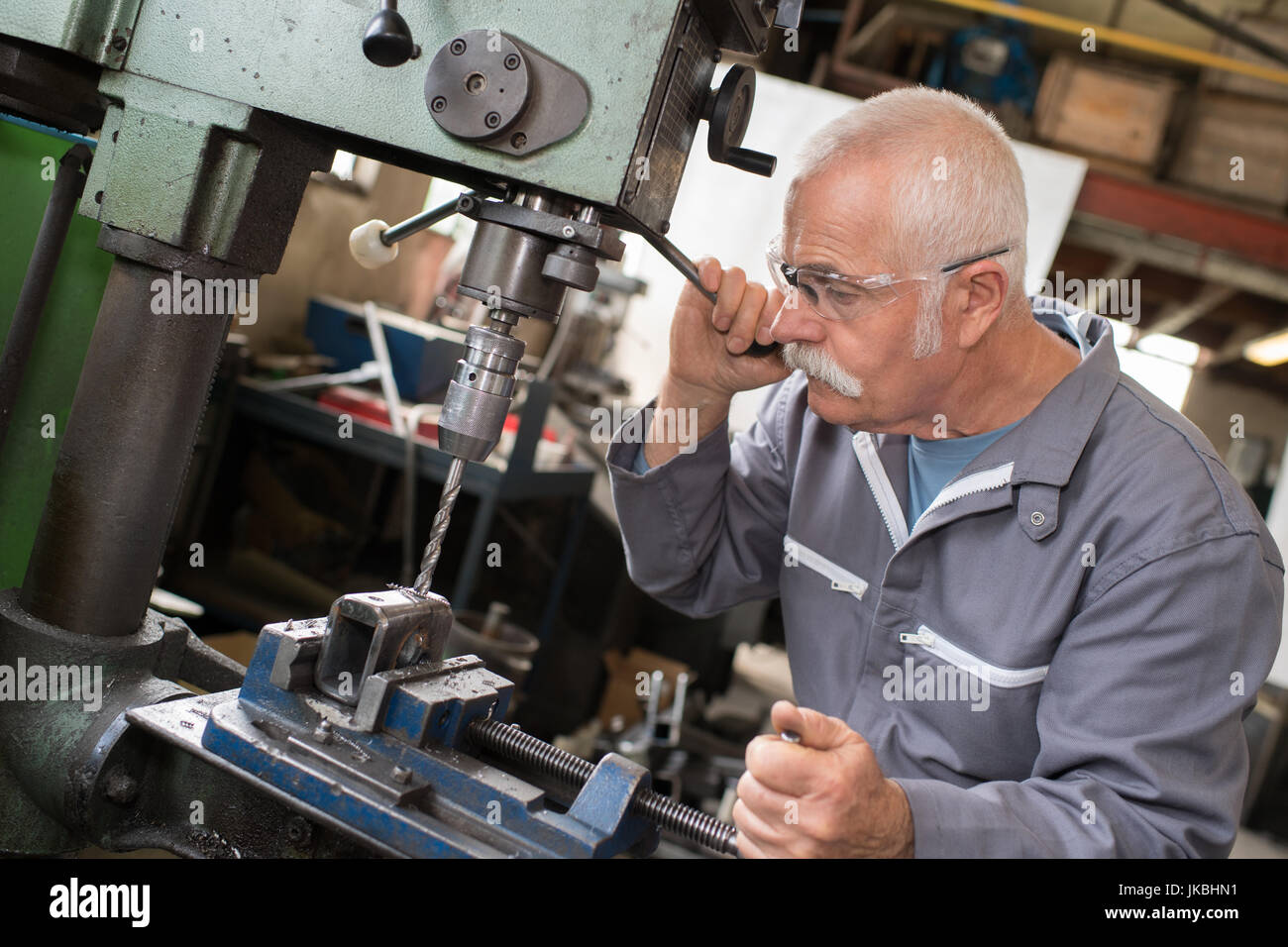 mechanic using industrial lathe machine Stock Photo - Alamy