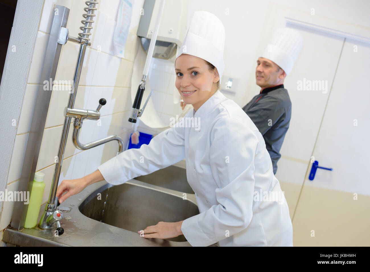 female chef washing his hands prior to preparing the cooking Stock ...