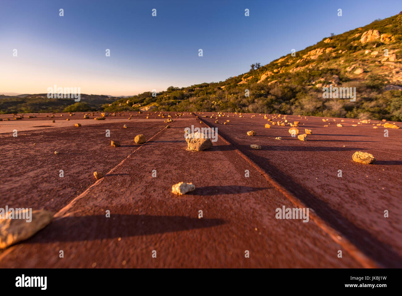 Rock lay splayed on top of a rusty water tower Stock Photo - Alamy