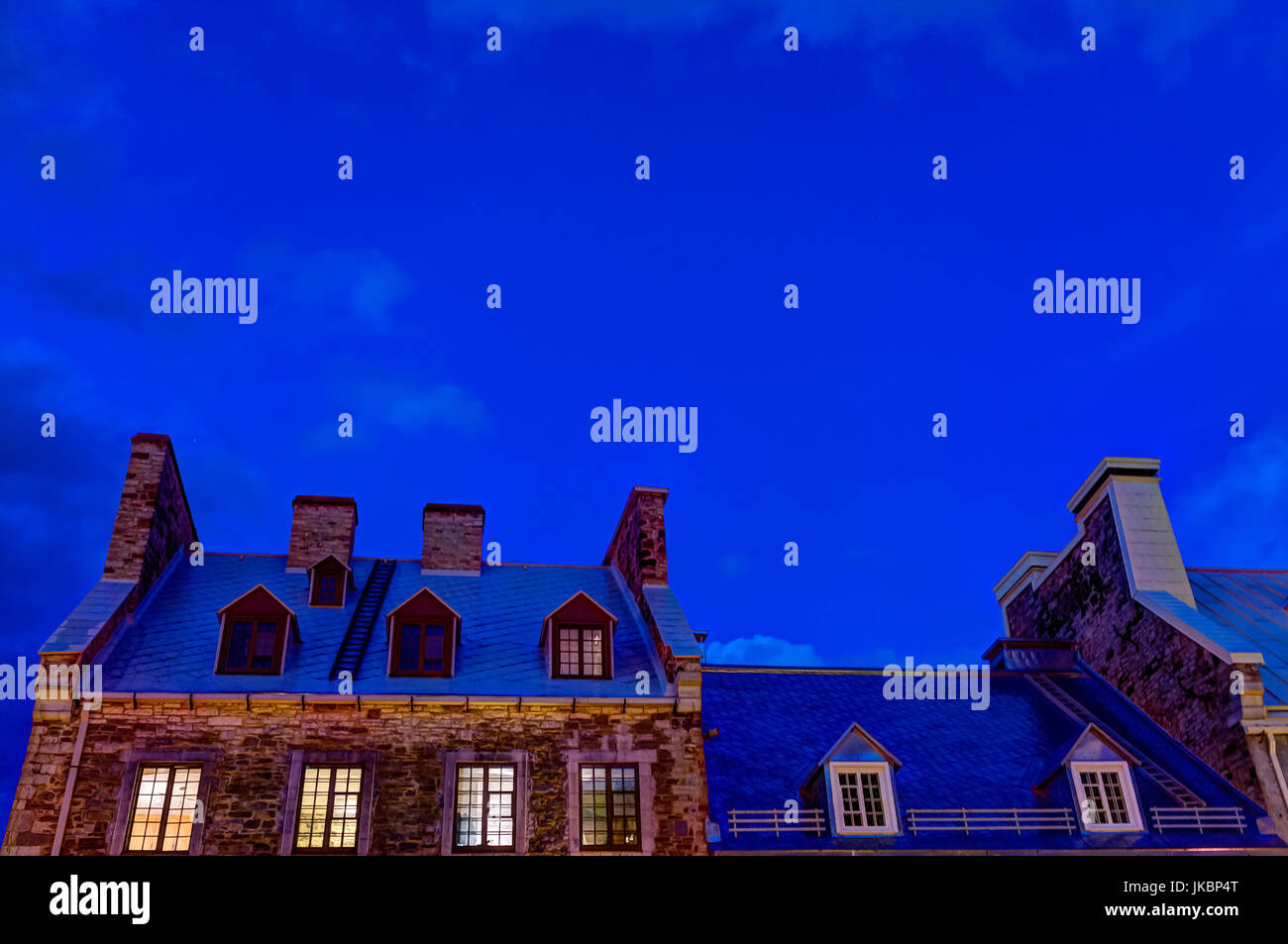 Skyscape of blue hour vibrant sky and European French building rooftops ...