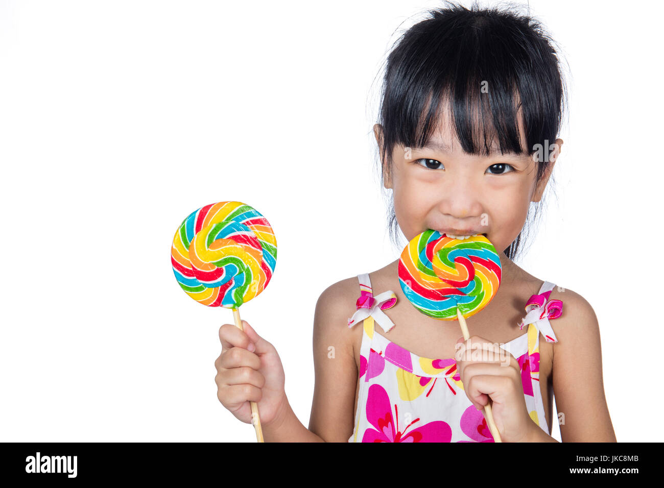 Asian Little Chinese girl eating lollipop in isolated white background ...