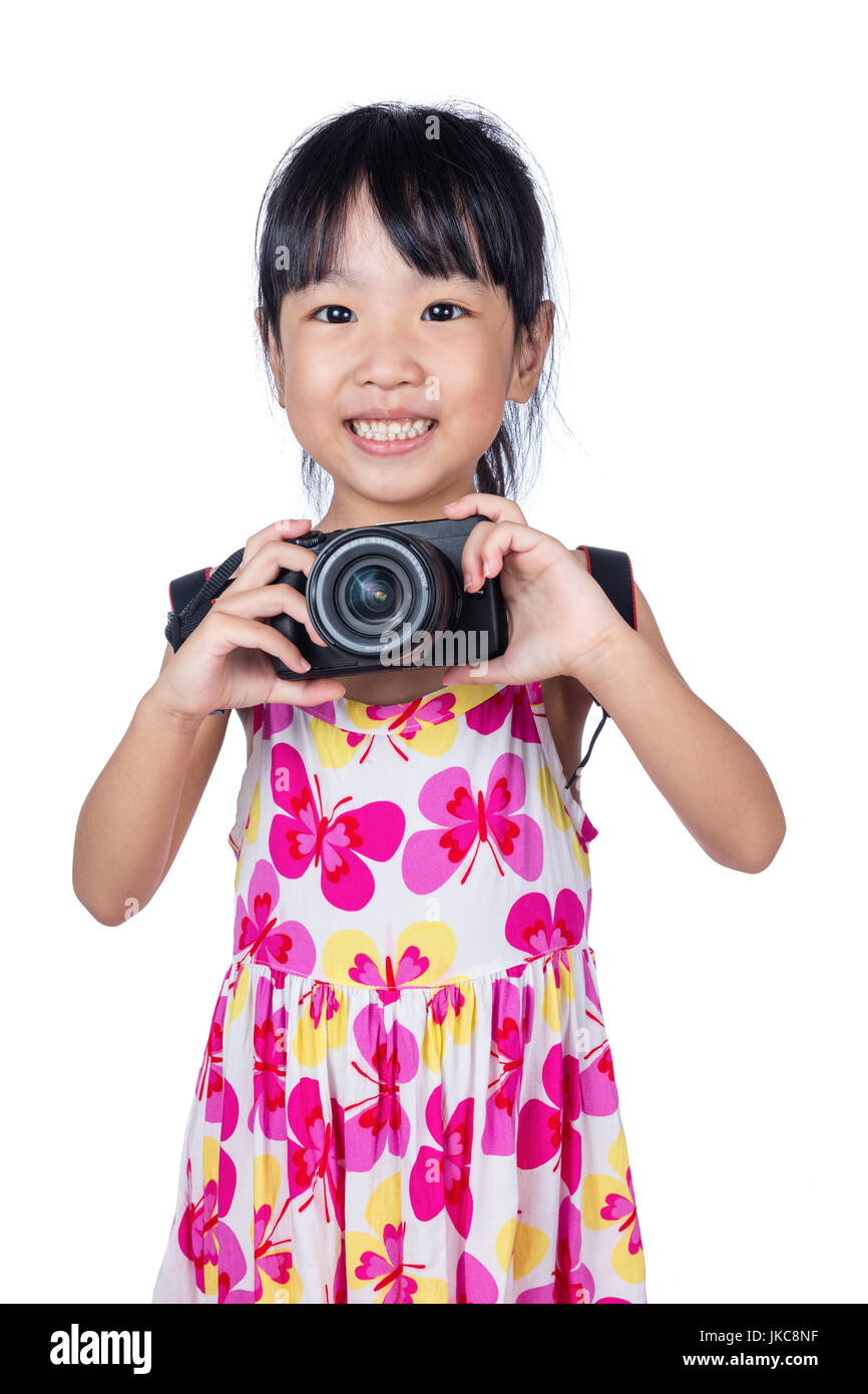 Asian Little Chinese girl holding a camera in isolated white background ...