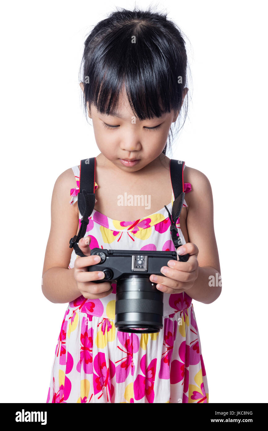 Asian Little Chinese girl holding a camera in isolated white background ...