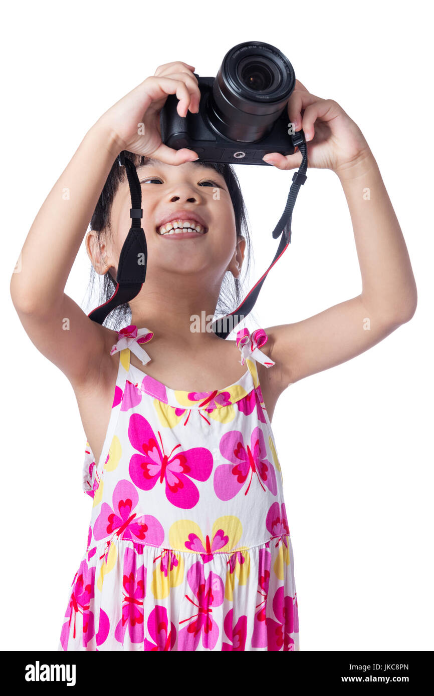 Asian Little Chinese girl holding a camera in isolated white background ...